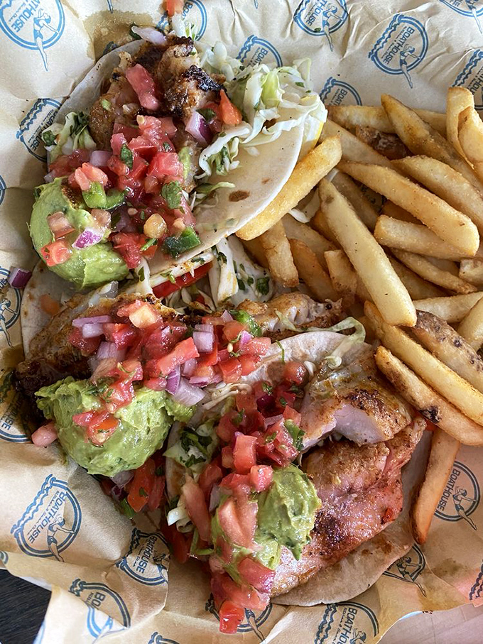 These fish tacos don't just swim, they soar—crispy battered fish, fresh pico, creamy avocado, and a side of golden fries that demand equal attention.