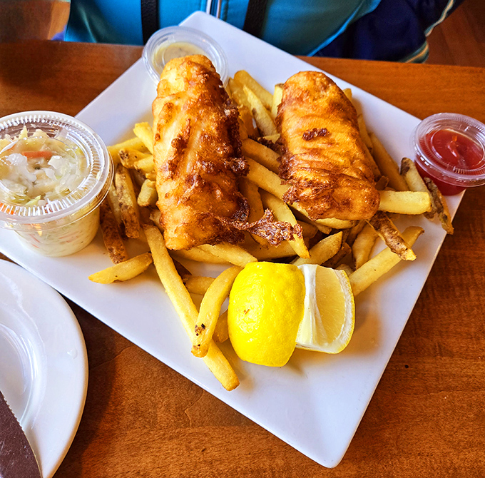 The star of the show: golden-battered fish and chips that crackle with each bite, served with a lemon wedge that's not just garnish—it's essential seasoning.