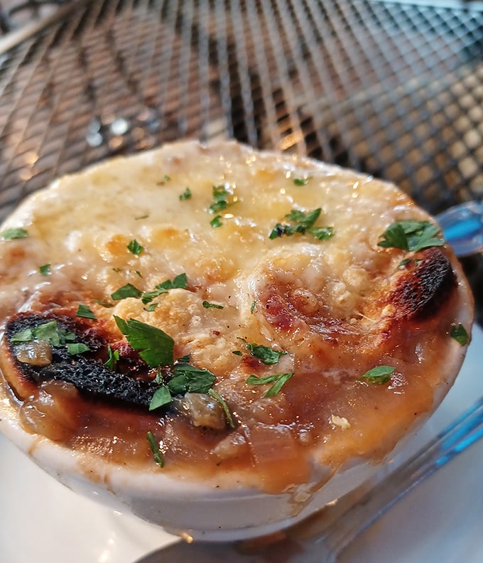 This isn't just French onion soup—it's a bubbling cauldron of cheese-capped comfort that demands to be cracked with a spoon.