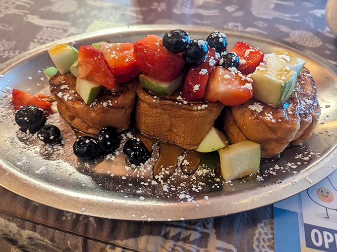 French toast that doesn't just cross the line between breakfast and dessert—it dances over it with fresh berries and a powdered sugar snowfall.
