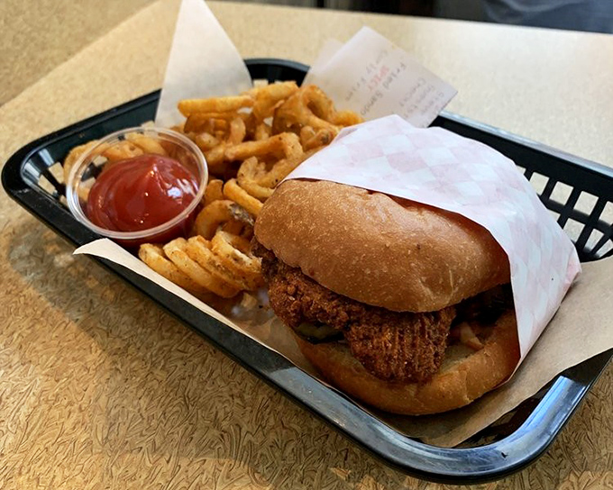 The platonic ideal of lunch: a sandwich that requires both hands, curly fries that defy gravity, and just enough guilt to know it's worth it.