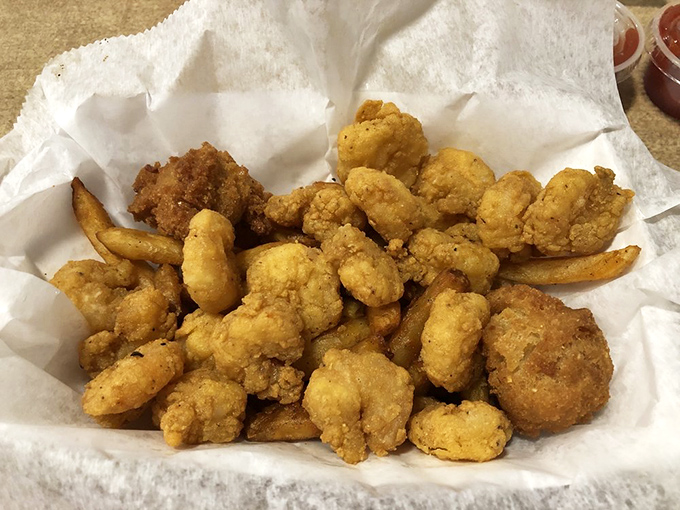 This basket of perfectly golden fried shrimp isn't just food—it's edible sunshine that locals will drive three counties over to experience.