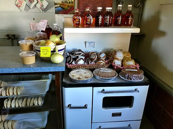 The vintage cookstove isn't just decoration—it's the workhorse behind these heavenly pies and pastries that line the simple country shelves.