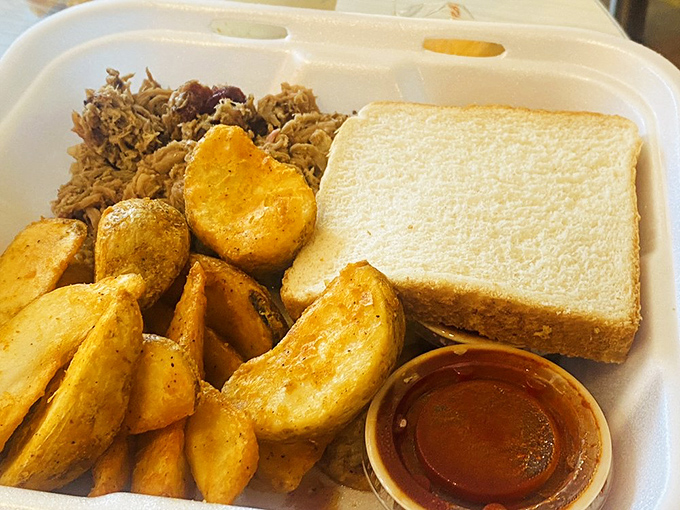 The holy trinity of comfort food: seasoned potato wedges, tender pulled pork, and Texas toast. This isn't just lunch—it's edible therapy for whatever ails you.