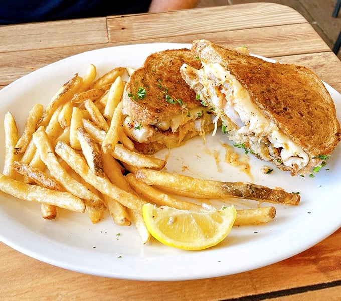 The legendary grouper sandwich – Florida's unofficial state food – served with crispy fries and a lemon wedge for that perfect citrus kick.