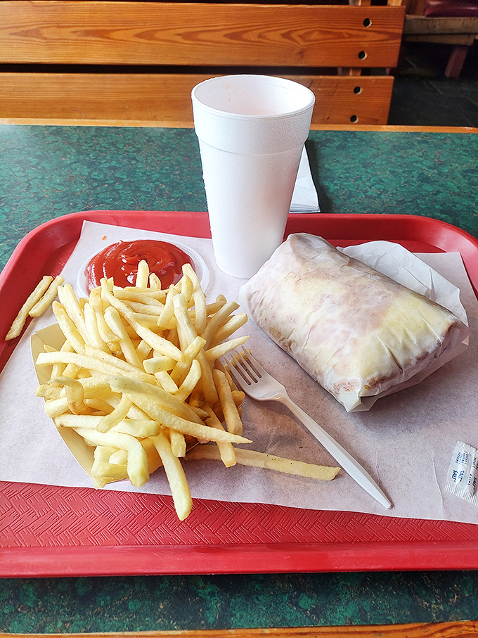 The perfect lunch trifecta: golden fries, a hefty sandwich wrapped in paper (nature's finest plate), and a drink large enough to quench a small army's thirst.