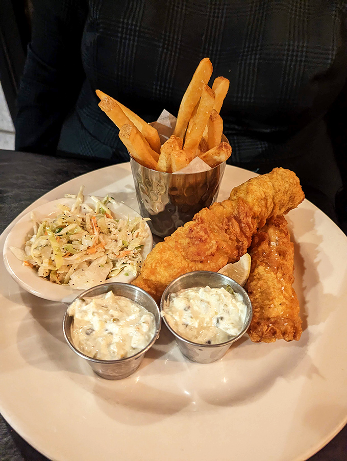 The legendary fish and chips in all their glory – crispy, flaky, and served with enough tartar sauce for proper dunking protocol.