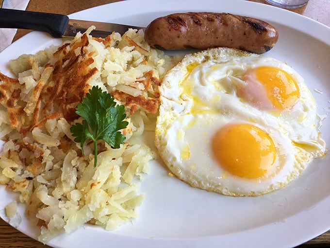 Morning perfection on a plate: sunny-side eggs with that magical moment when yolk meets perfectly crisped hash browns.