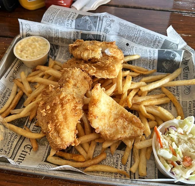 Golden-battered fish nestled on a mountain of fries—this isn't just lunch, it's edible sunshine with a side of vacation vibes.