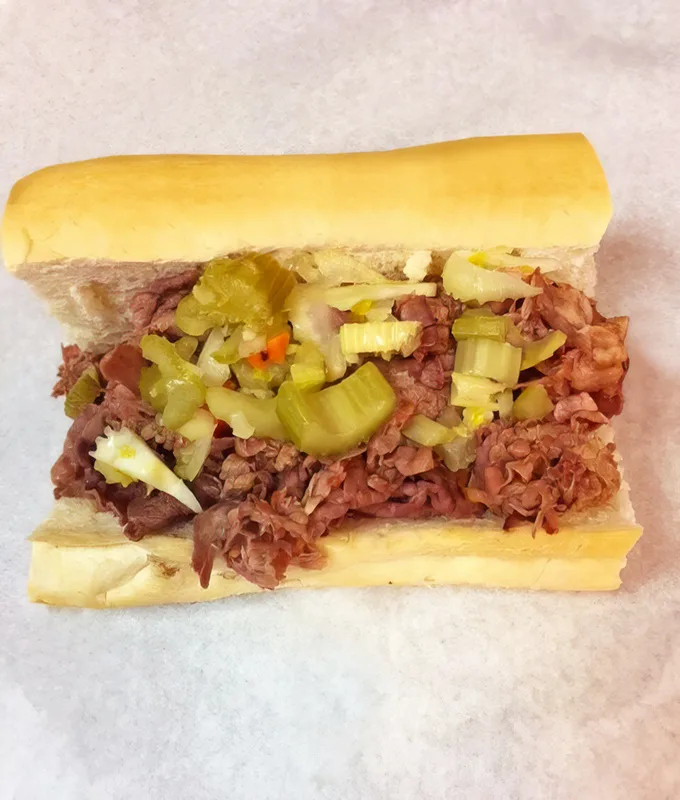 The Italian beef in its natural habitat: thinly sliced, perfectly seasoned, topped with giardiniera. Chicago's gift to sandwich civilization.