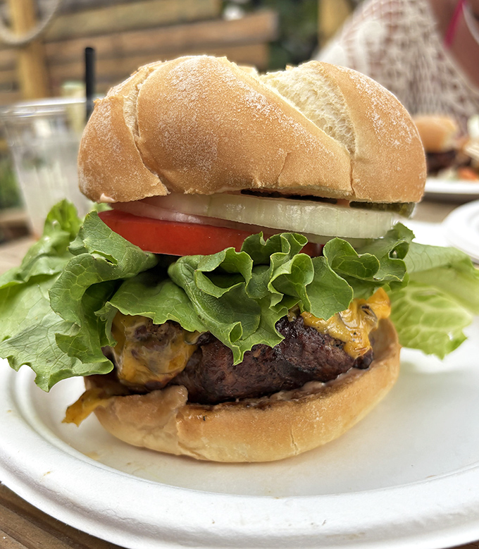 Behold the legendary burger that launched a thousand road trips—simple, substantial, and served with just enough toppings to complement that glorious patty.