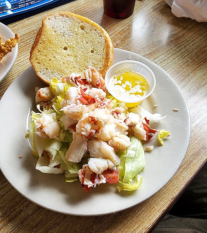 The seafood salad doesn't shout for attention but whispers of fresh-caught delights, served with a slice of bread that's ready for its supporting role.