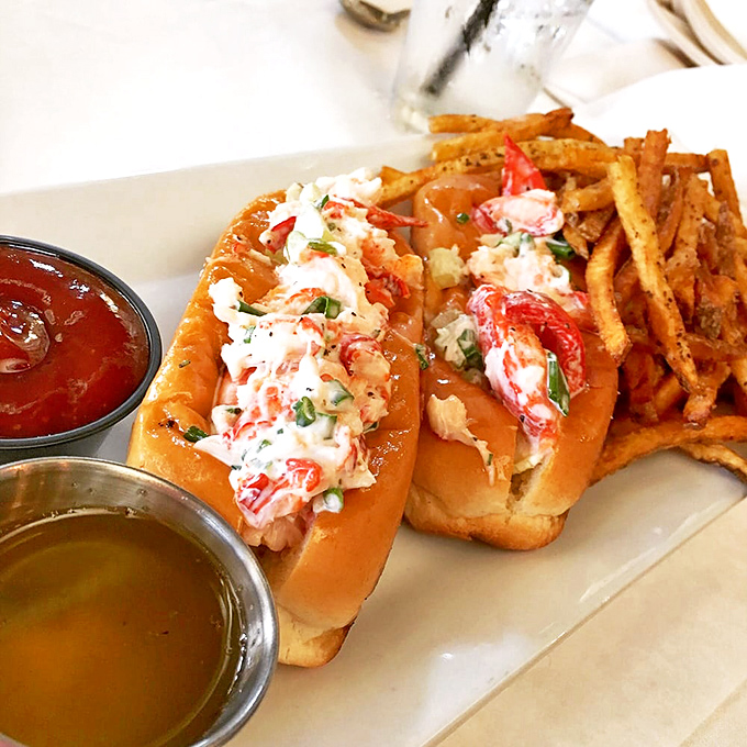 This lobster roll doesn't just speak of the sea—it practically recites maritime poetry, accompanied by fries that demand equal attention.