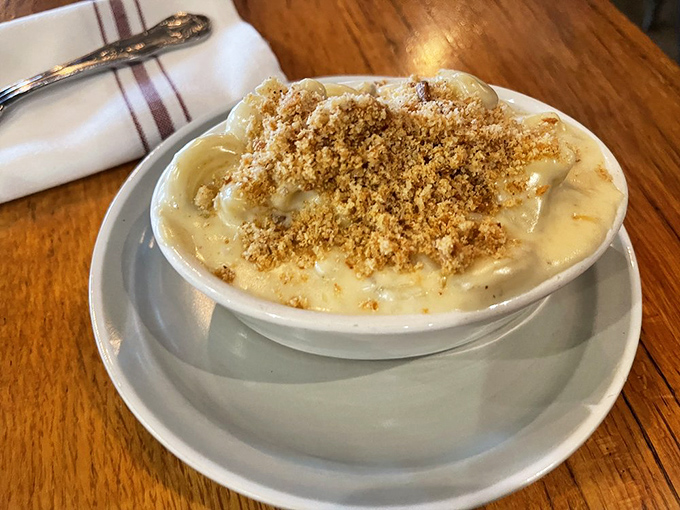 The crown jewel that launched a thousand road trips. Golden breadcrumbs atop molten cheese—this isn't just mac and cheese, it's edible therapy.