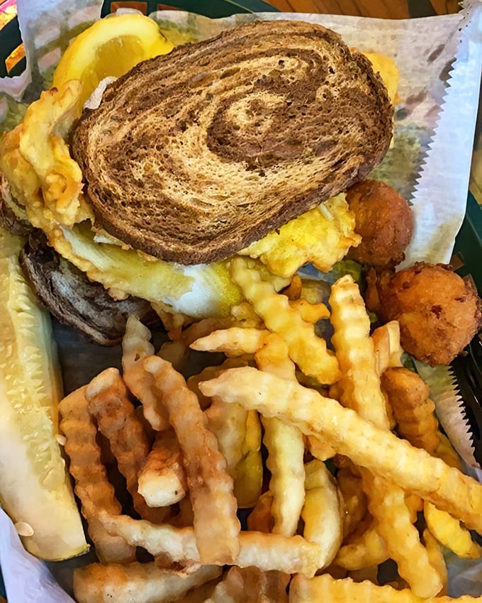 The Mahi Reuben—where deli meets ocean in a marbled rye love story. Swiss cheese melting over blackened fish is Florida's answer to Manhattan.