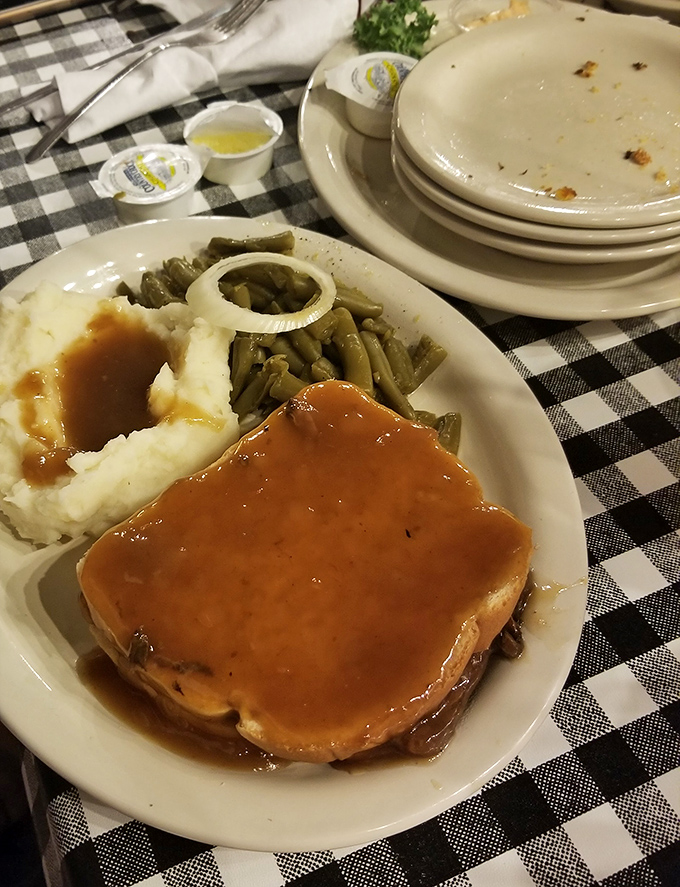 Meatloaf that doesn't just sit on the plate – it commands respect. Paired with those mashed potatoes and green beans, it's Kentucky's answer to a hug.
