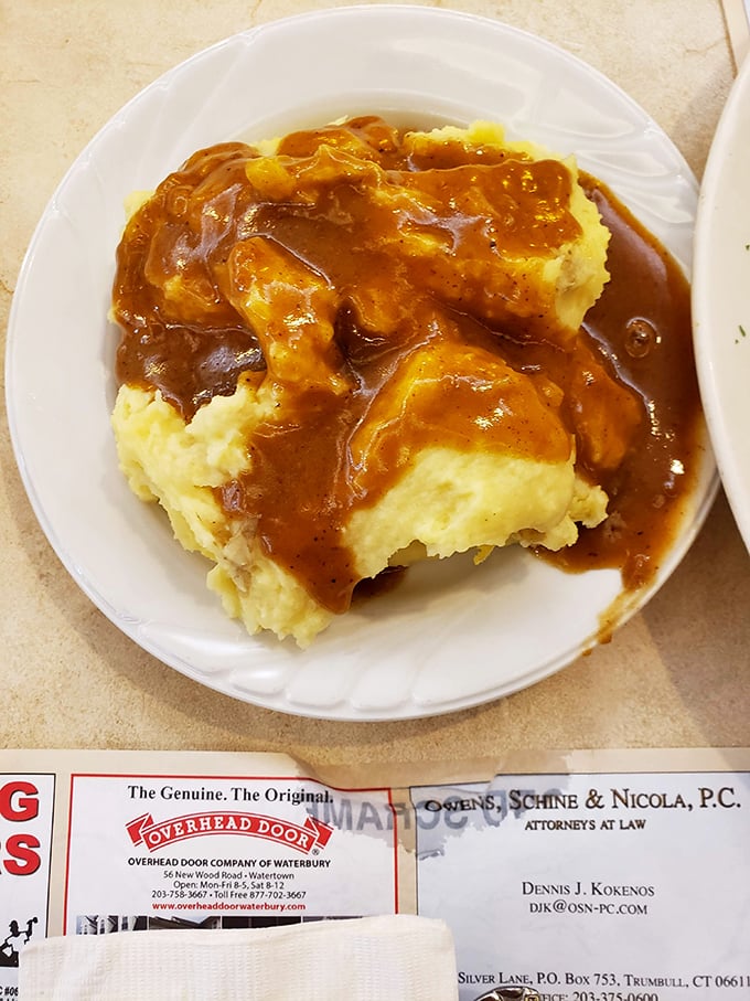 Those mashed potatoes aren't just a side dish – they're a golden lake of buttery goodness waiting for that river of homemade gravy. Pure comfort on a plate.