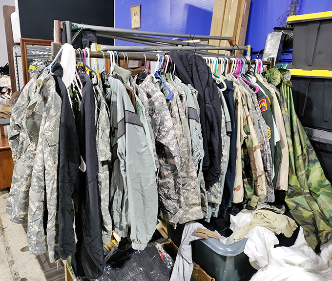 Military and outdoor gear hangs in formation, each jacket with stories stitched into its seams, waiting for new adventures.