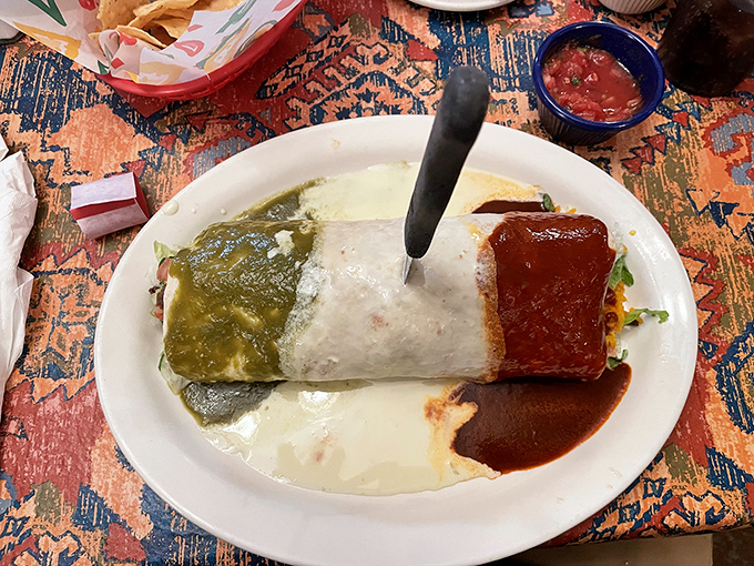 The Mexico City Burrito arrives like the flag of deliciousness—green sauce, white tortilla, and red sauce forming a patriotic tribute to flavor.