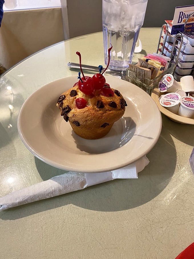 This chocolate chip muffin topped with cherries isn't just breakfast—it's dessert with an alibi, standing proud as morning's guilty pleasure.