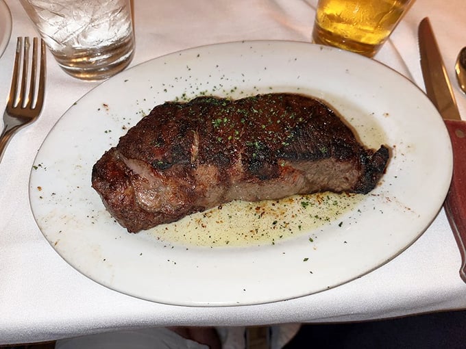The New York Strip arrives with the kind of char that makes meat lovers go silent mid-conversation. This is beef worth contemplating.