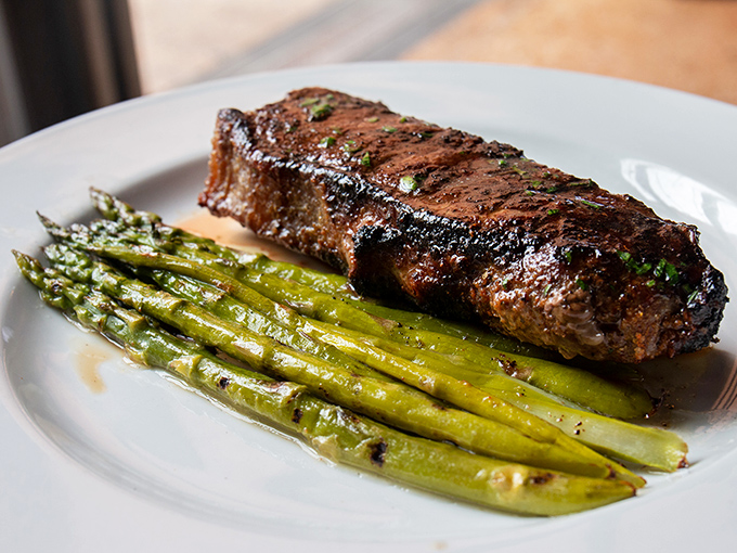 A perfectly seared New York strip with asparagus—proof that simplicity, when executed flawlessly, creates the most profound food memories.