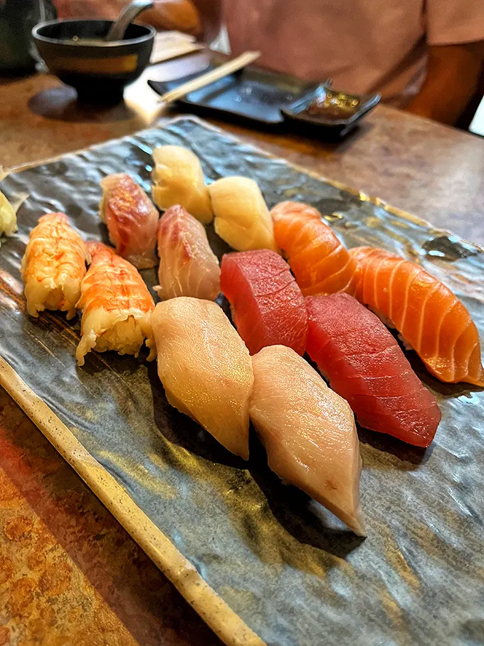 Nigiri perfection – each piece a testament to the chef's precision. The fish glistens like it's still contemplating its life choices.