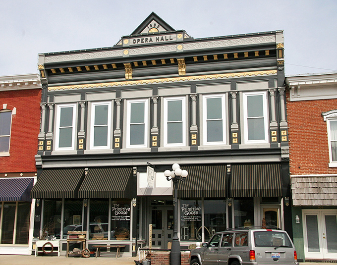 The Opera Hall façade proves that even small towns once prioritized cultural experiences alongside their hardware stores.