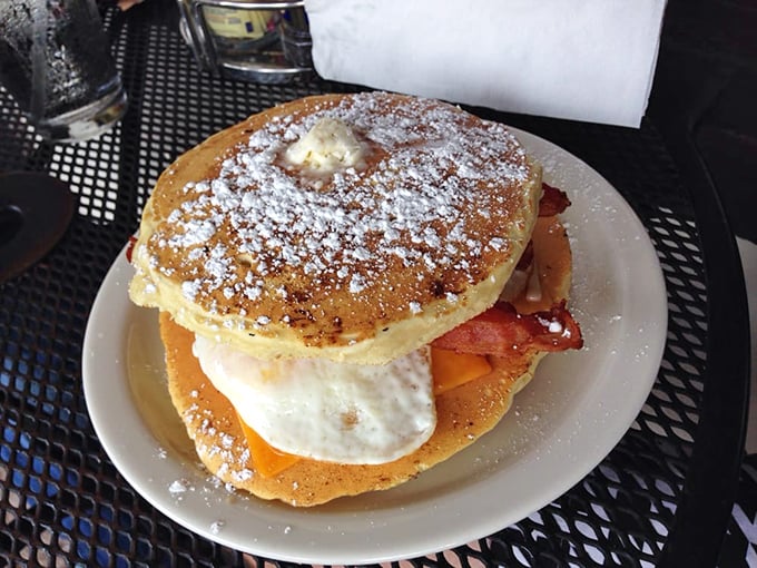 The Pancake Sammy laughs in the face of food boundaries—fluffy pancakes, eggs, bacon, and powdered sugar in perfect harmony. Breakfast identity crisis never tasted so good.