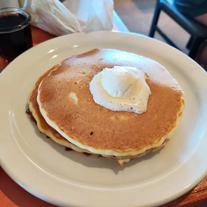 This isn't just a pancake—it's a fluffy throne for that perfectly cooked egg, waiting to release its golden treasure.