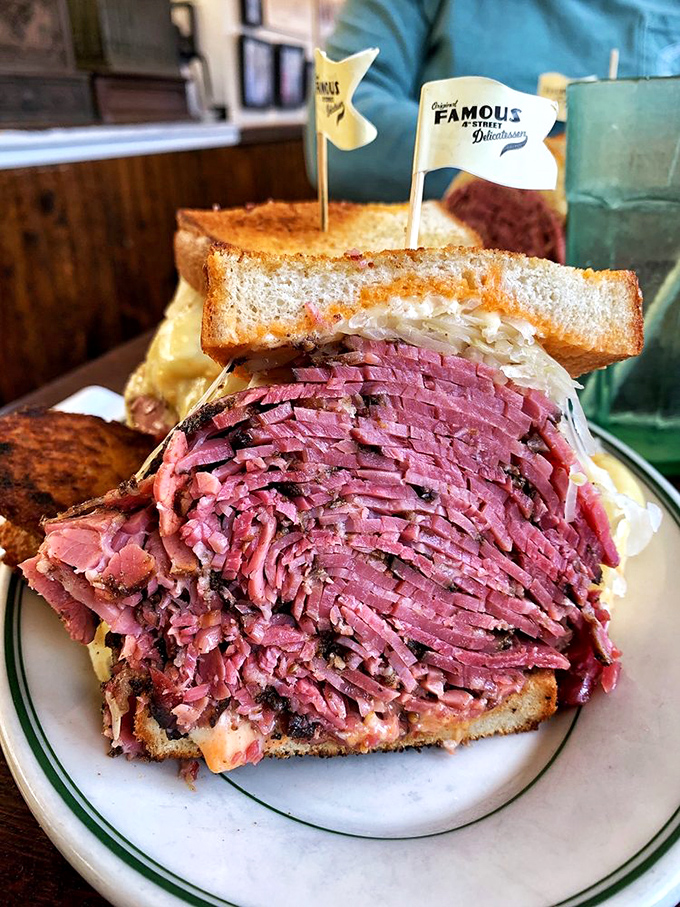 The pastrami at Famous 4th doesn't just melt in your mouth; it throws a flavor party and invites all your taste buds. That little flag isn't decoration—it's claiming territory.