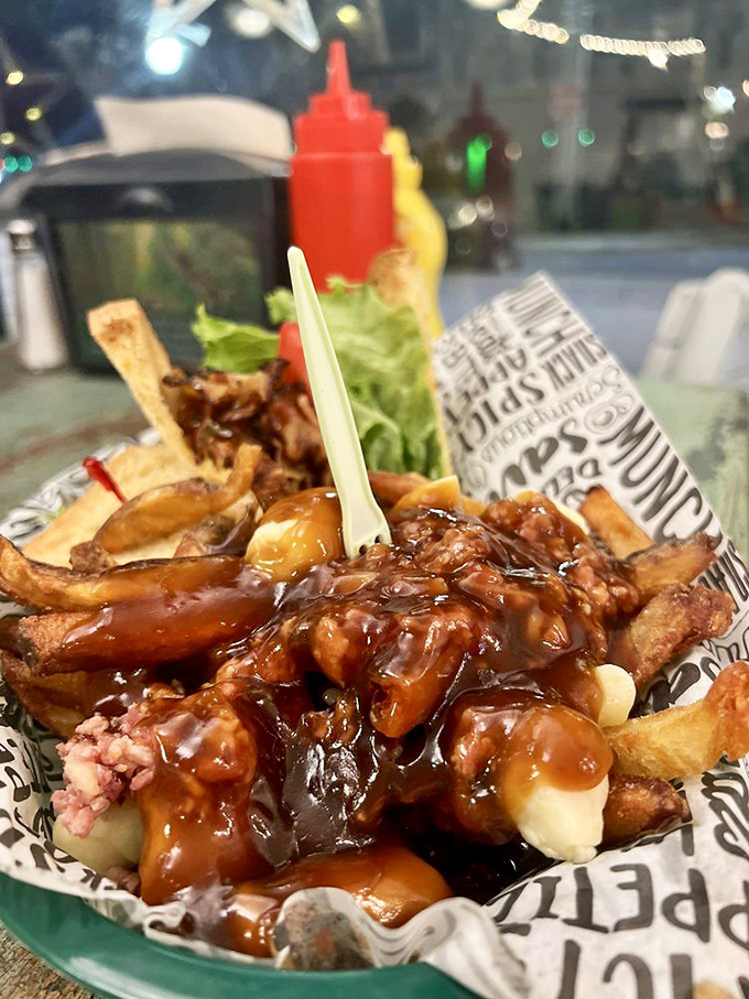 Poutine that would make Canadians nod in approval—crispy fries somehow maintaining their dignity beneath a deluge of savory gravy and melty cheese.