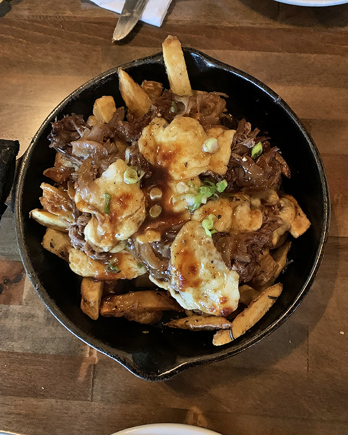 This isn't your average poutine—it's a skillet of rebellion where crispy fries, melty cheese, and savory pulled meat create a harmony that would make Mozart jealous.
