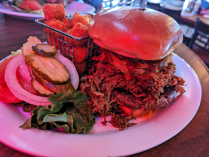 This isn't just a pulled pork sandwich—it's a monument to slow-cooked perfection, piled so high it requires strategic planning before the first bite.