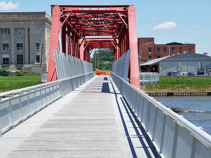 This crimson pedestrian bridge isn't just functional—it's a splash of architectural whimsy connecting Des Moines' practical past with its vibrant present.