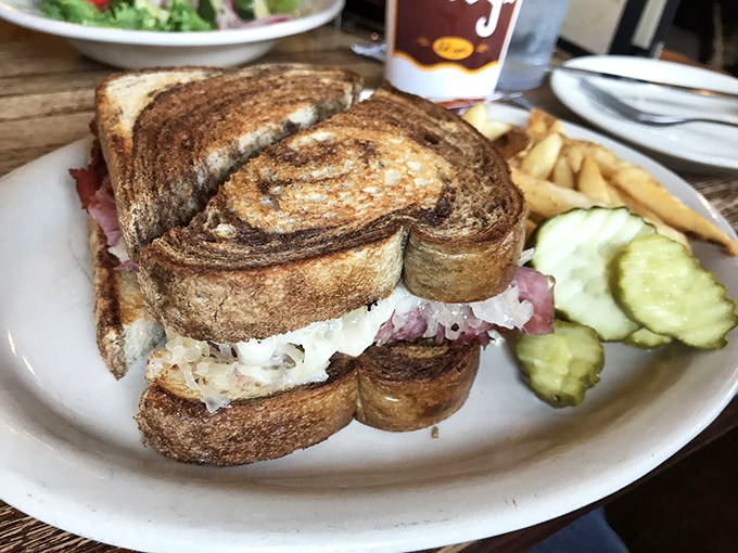 Behold the architectural marvel that is Kuby's Reuben – layers of meat and sauerkraut creating the sandwich equivalent of Beethoven's Fifth Symphony.