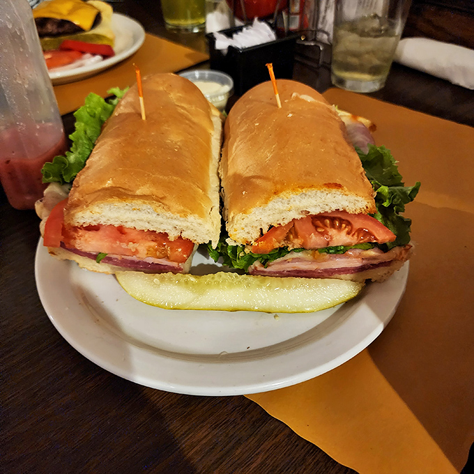 When a sandwich requires structural engineering and toothpicks to hold it together, you know you're in Pittsburgh. This isn't lunch—it's an event.