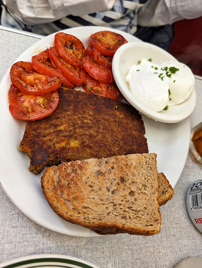 This plate tells a California story—perfectly roasted tomatoes, a golden-brown scrapple, and poached eggs that belong in the breakfast hall of fame.