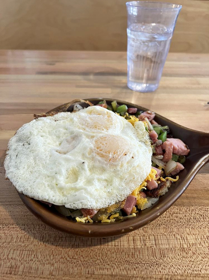 Eggs perched majestically atop a mountain of savory ingredients. This skillet doesn't just feed you—it prepares you for conquering actual mountains afterward.