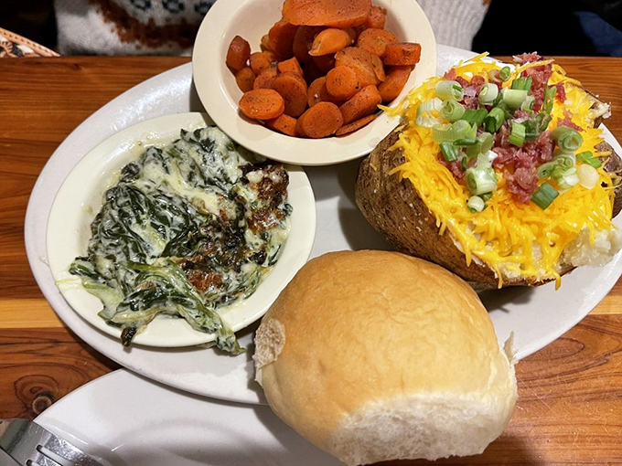 Side dishes that refuse to be sidekicks—creamy spinach, sweet carrots, and a loaded baked potato that could easily steal the spotlight from any entrée.