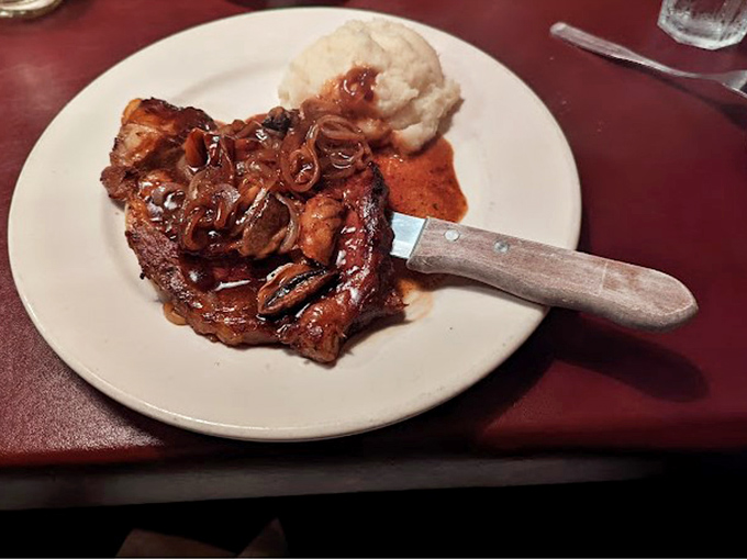 This pork chop with caramelized onions and mashed potatoes isn't just dinner—it's the kind of meal that makes you temporarily forget your own name.