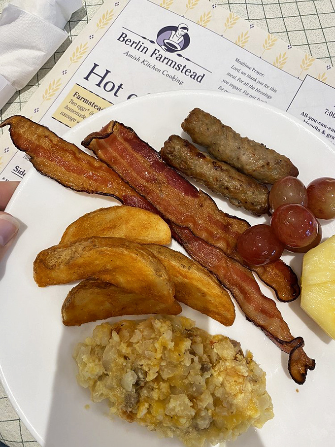 A breakfast plate that speaks the universal language of "good morning" – crispy bacon, golden home fries, and hash brown casserole that demands to be savored, not rushed.
