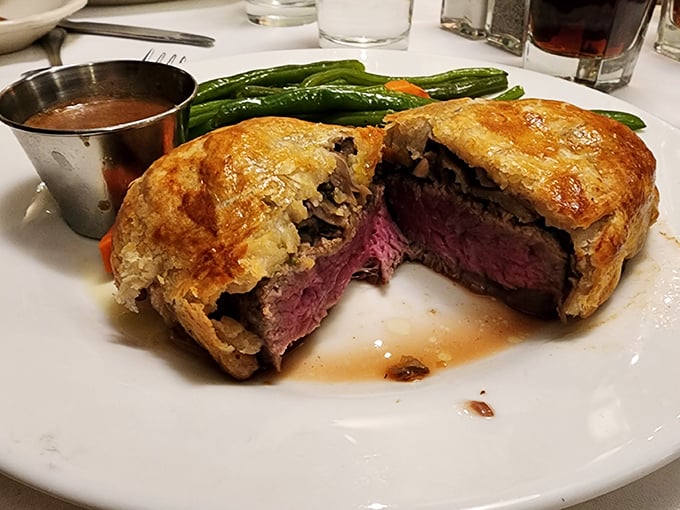 Beef Wellington that would make Gordon Ramsay weep tears of joy—a perfectly pink center encased in golden pastry that shatters like childhood dreams.
