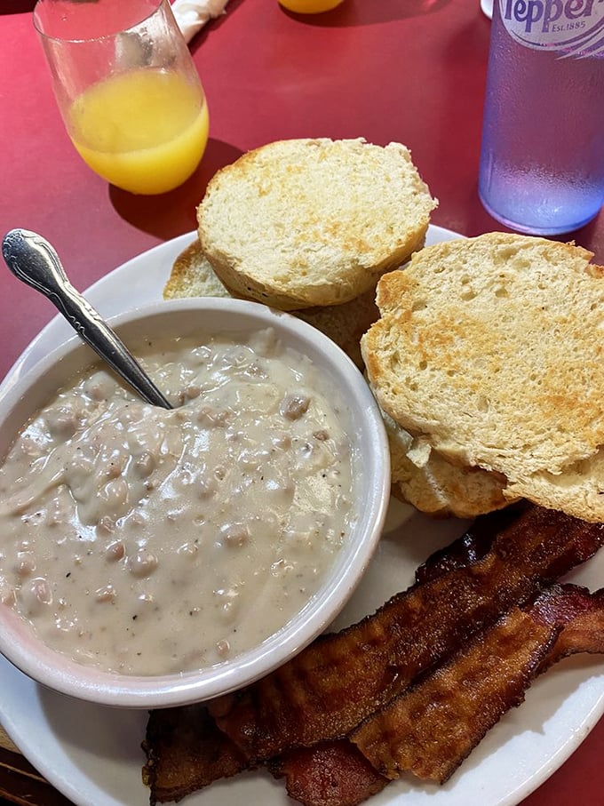 The holy grail of comfort food: creamy sausage gravy ladled over golden biscuits with crispy bacon on standby. Grandma would approve.
