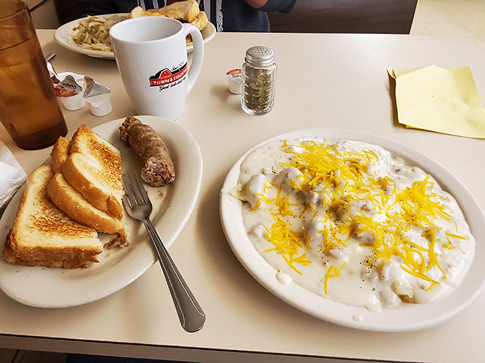 Breakfast of champions: sausage, toast, and gravy-smothered potatoes with cheese. The kind of morning fuel that makes hitting the snooze button a cardinal sin.