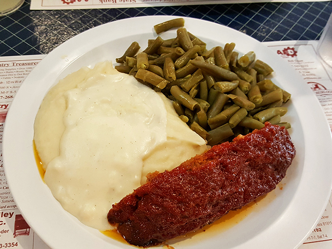 The breakfast plate that launched a thousand farm days—golden potatoes and sweet corn flanking what might be the Midwest's most comforting gravy.