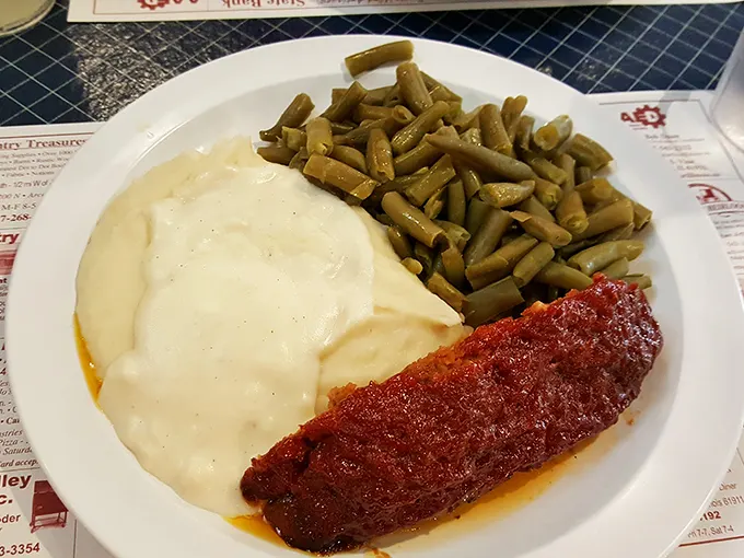 The breakfast plate that launched a thousand farm days—golden potatoes and sweet corn flanking what might be the Midwest's most comforting gravy.