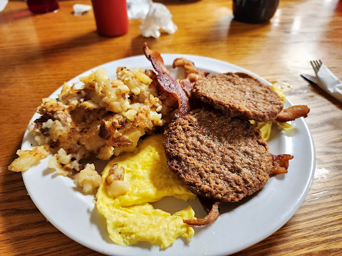 The breakfast trinity: golden eggs, crispy potatoes, and scrapple that would make any diner devotee weak in the knees.