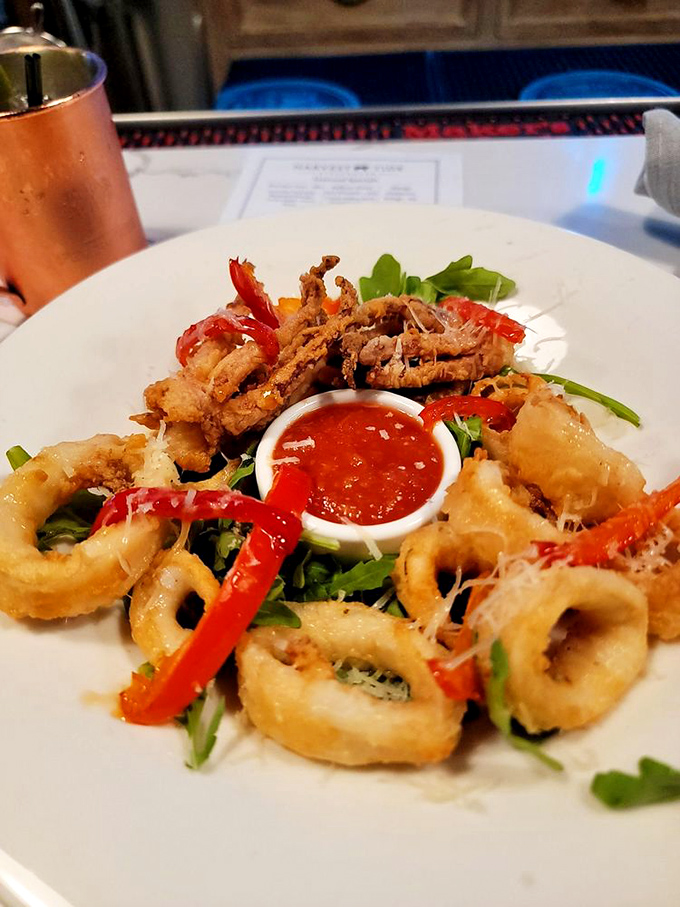 Crispy calamari and sweet peppers perform a delicate balancing act, with that vibrant dipping sauce standing by like a faithful wingman.