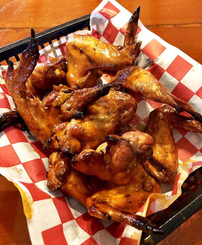 These wings aren't trying to fly – they've found their higher purpose as vehicles for smoky, sticky, finger-licking goodness.